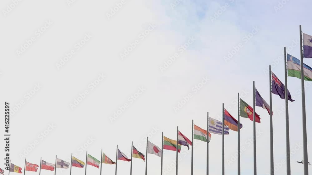 National state flags of many countries waving in the wind on the alley ...