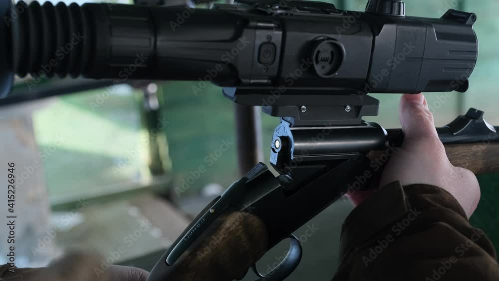 The man is loading a cartridge into a gun. Hunter's hand is loading a ...