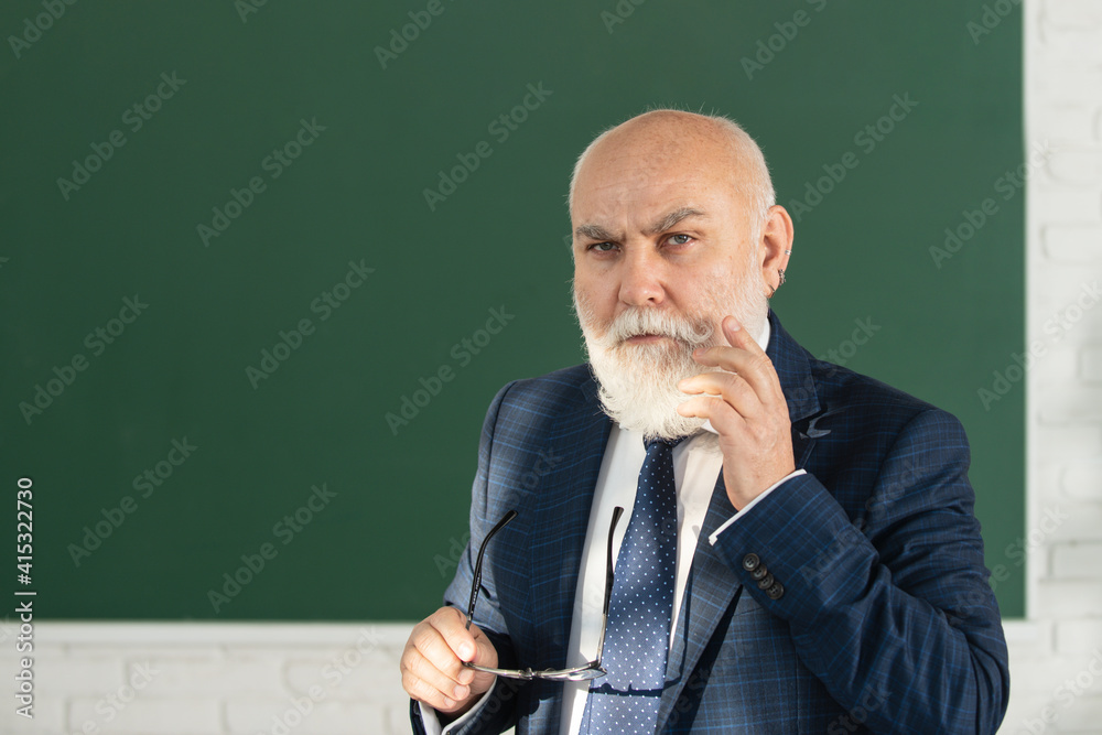 Grey hair professor in empty lecture classroom. People scientist ...