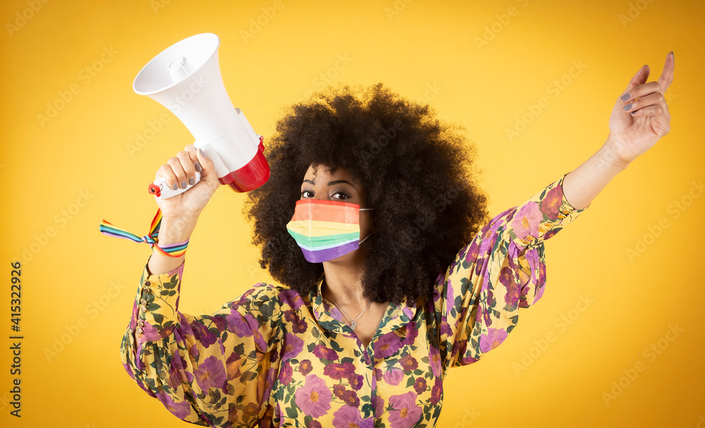 Beautiful lesbian African American woman with LGBT rainbow flag. Curly ...