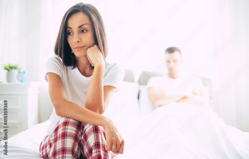 Young unhappy married couple in bedroom. Serious quarrel in family ...
