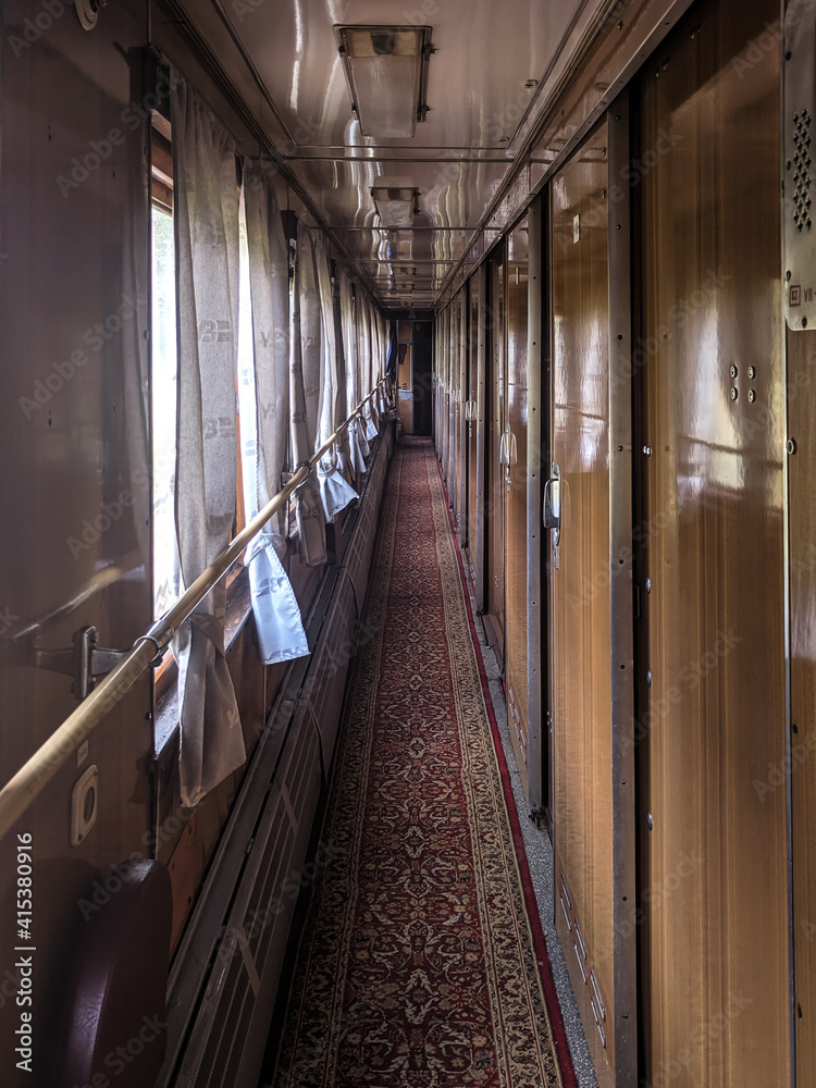 Inside Ukrainian train. Long corridor in a wagon car in warm colors ...