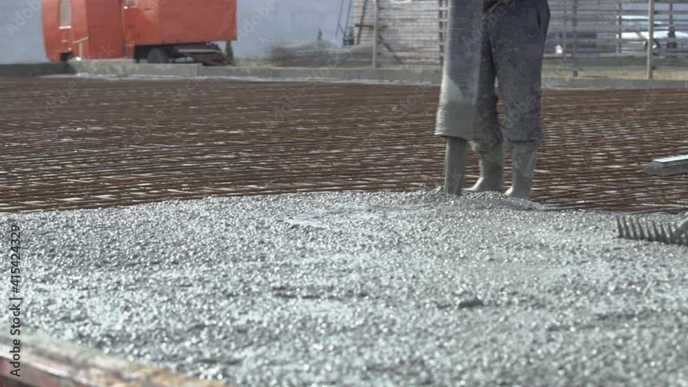 Worker concreting foundation, reinforcement, pour cement mortar on ...