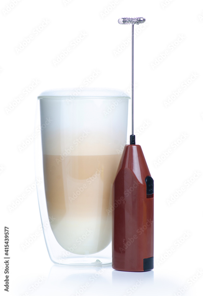 Mini hand mixer for milk with glass cup of coffee latte on white ...