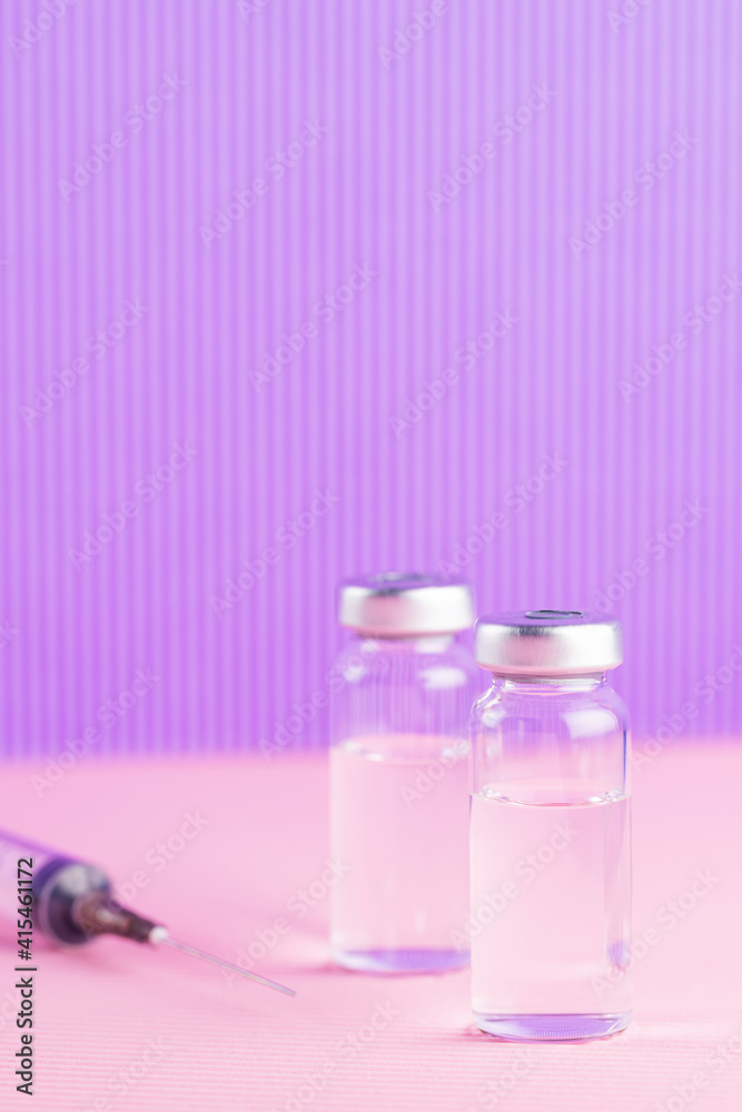 Vaccines and syringe on a pink purple background for prevention and ...