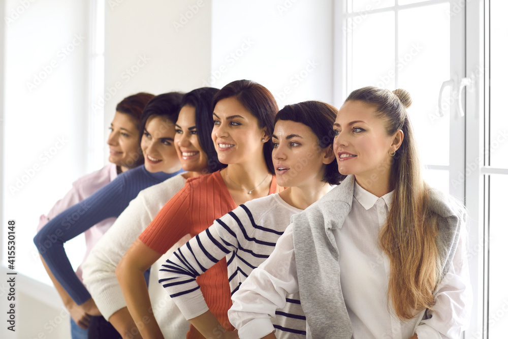 Profile view of group of happy confident young women in their 20s and ...