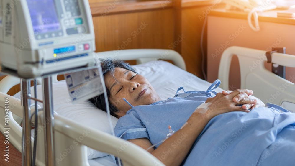 Hospitalized elderly patient senior woman sleeping on bed in hospital ...