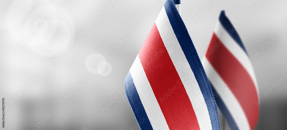 Small national flags of the Costa Rica on a light blurry background ...