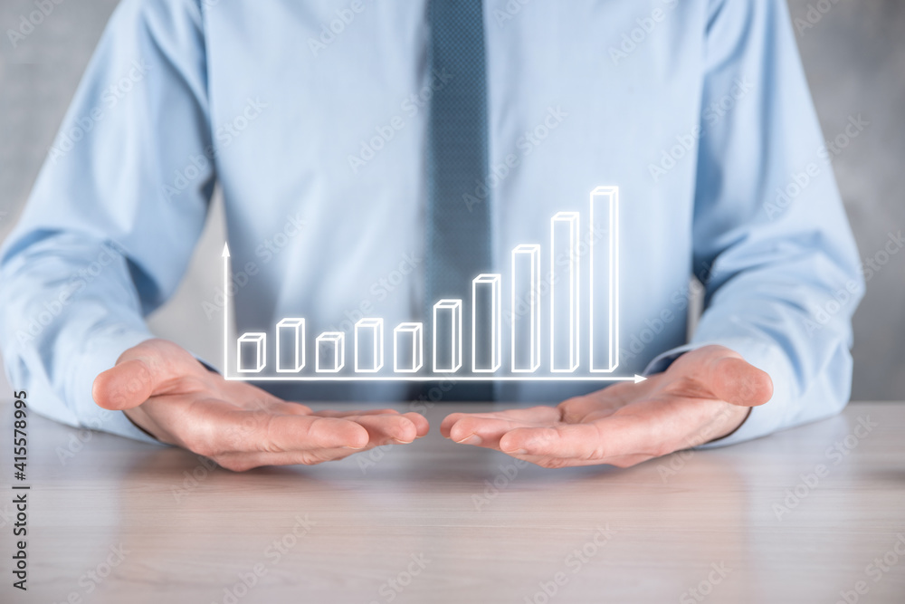 Businessman man holding a graph with positive profits growth. plan ...