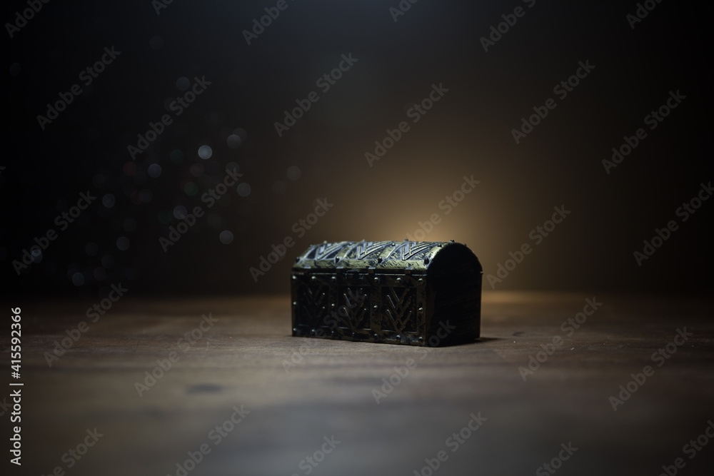 A dark wooden treasure chest with lid closed on wooden table. Stock ...