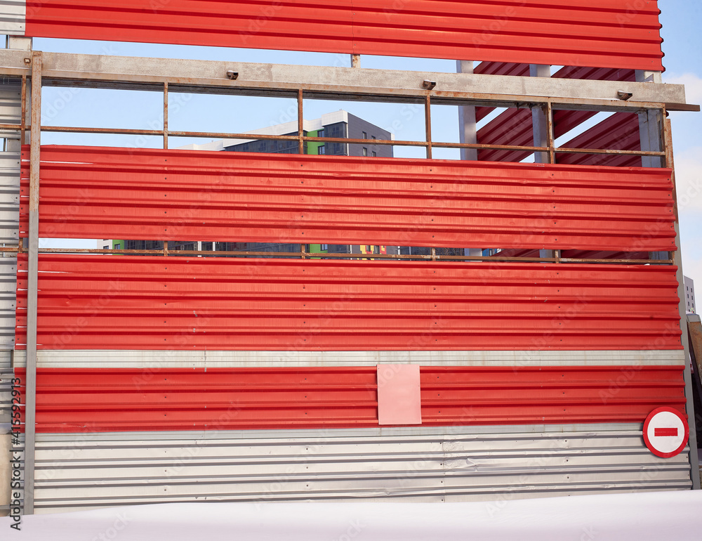 the wall of an industrial building with a sliding gate. winter view ...