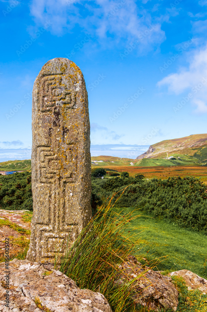 An ancient Celtic stele stone monolith with many of old carvings still ...
