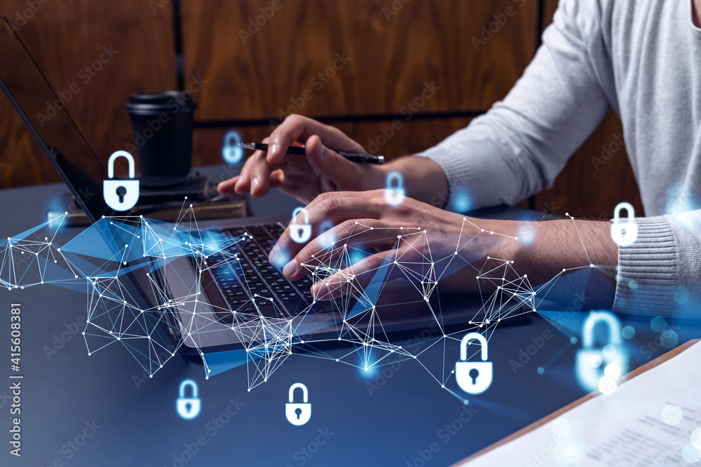 A programmer is typing a code on a keyboard to protect a cyber security from hacker attacks and ...