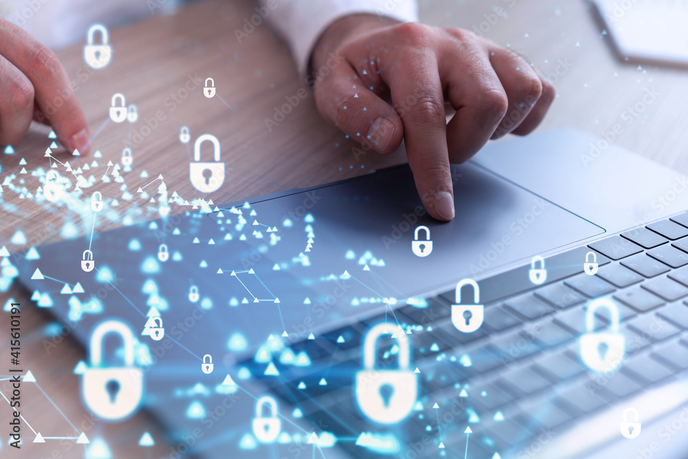 A programmer is typing a code on computer to protect a cyber security ...