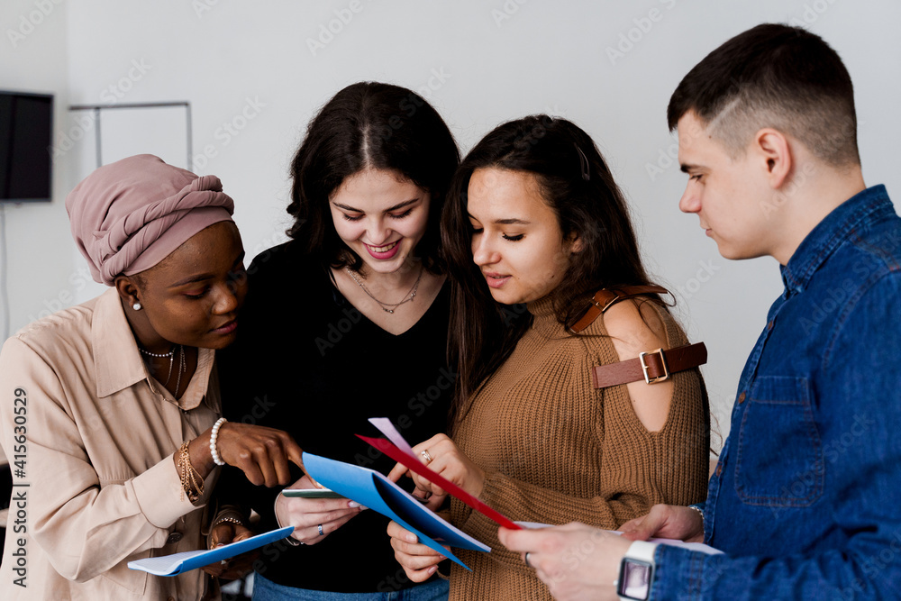 Multiethnic students and teacher study foreign languages together in ...