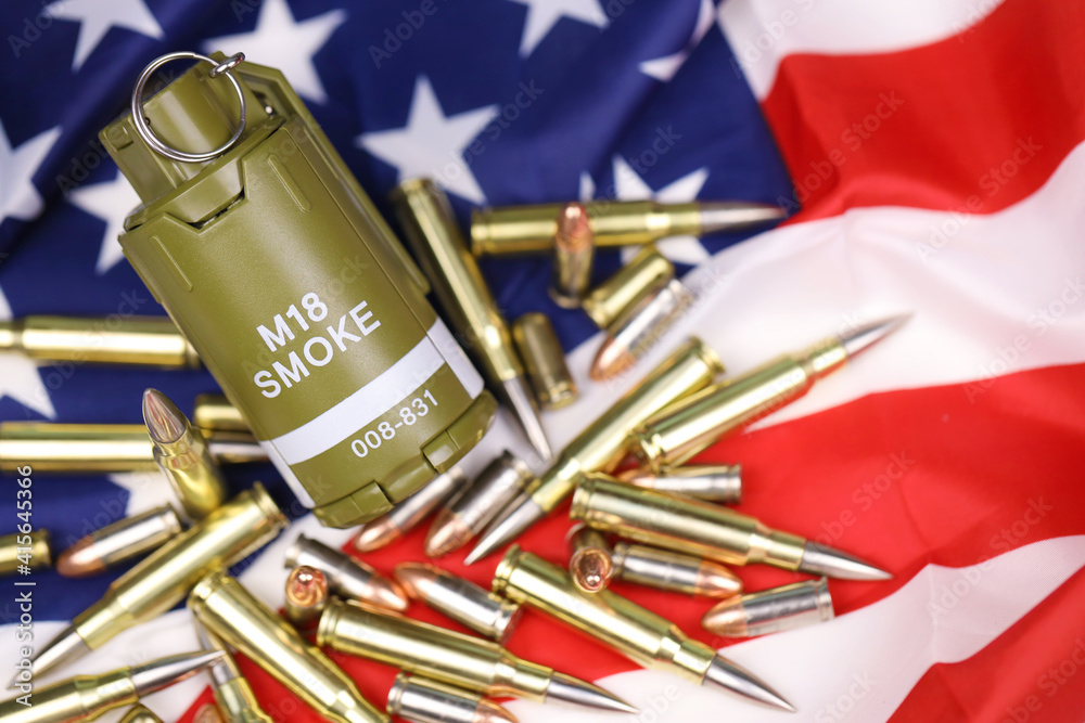 M18 smoke grenade and many yellow bullets and cartridges on United ...