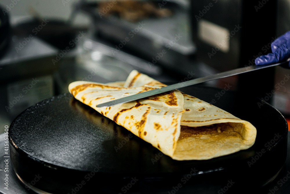 The pancake is fried and cooked in a large iron roti maker pan. Indian ...