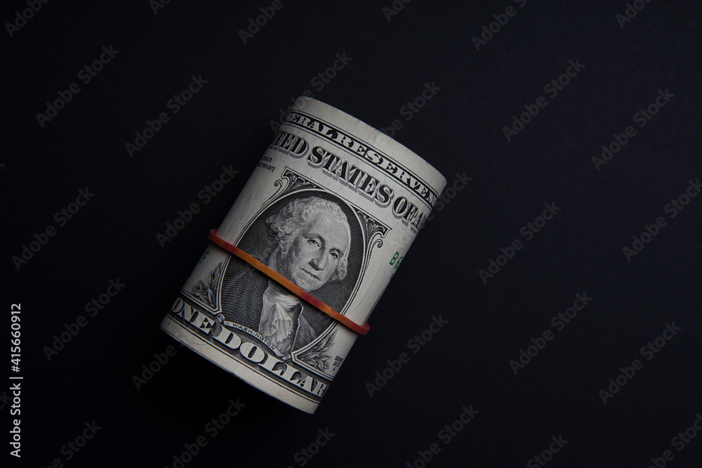 Money rolls wrapped with red rubber band isolated on black background ...