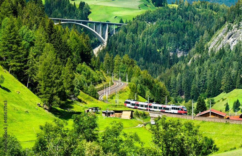 Regional train at the Brenner Railway in the Austrian Alps Stock Photo ...