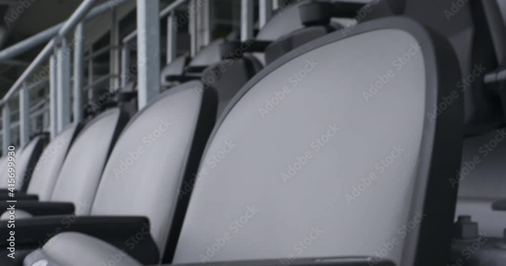 Close shot of empty stadium seats in slow motion with movement up and ...