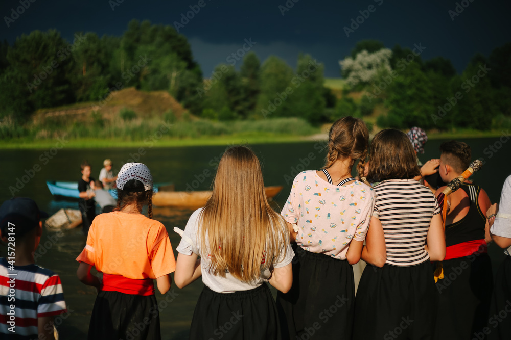 Foto de Group of children stand from backs and cheer for their friends ...