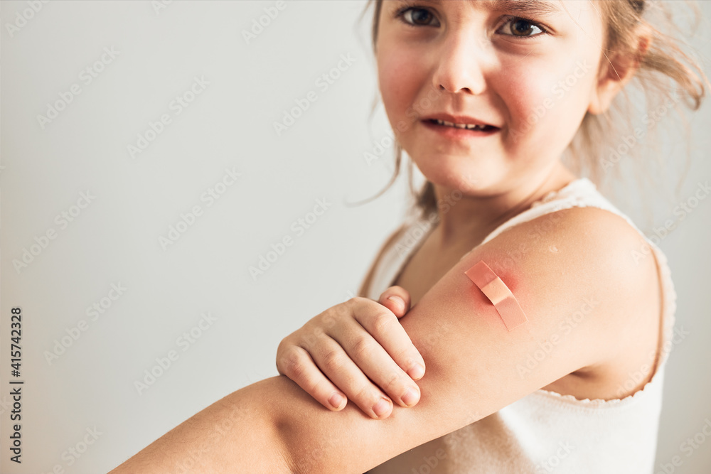 Little girl feeling pain having some side effects after vaccination ...