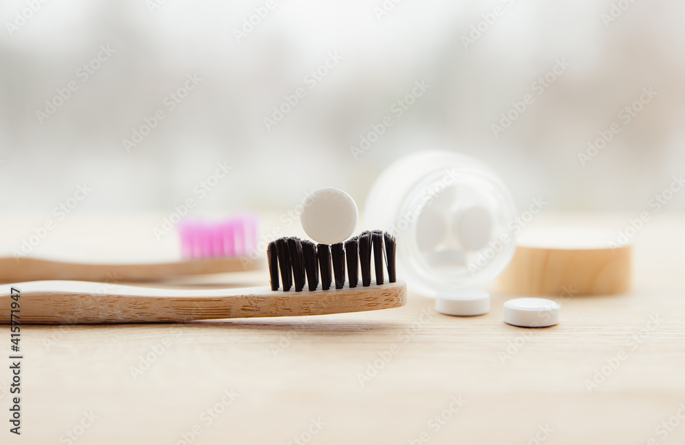 Side view of white toothpaste tablets with fluoride. Dental care ...