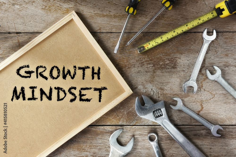 Growth mindset word on frame with tools supplies on wooden background ...