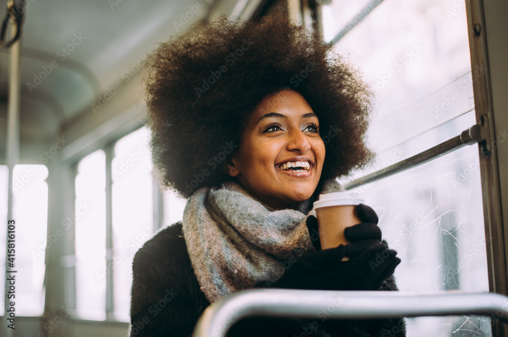 Beautiful girl with afro haircut portraits in the public transport ...