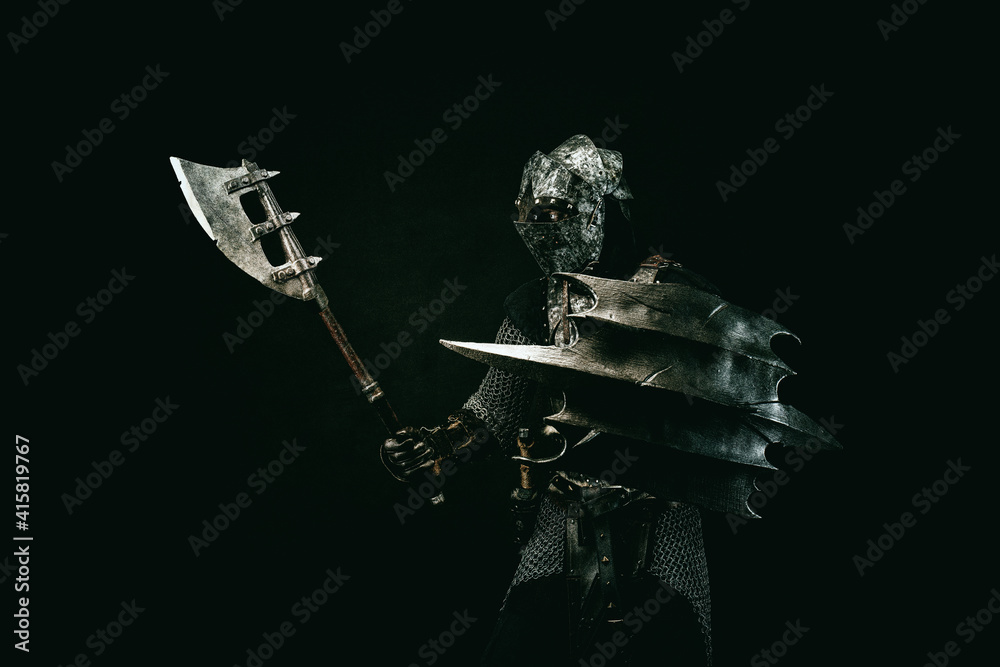 Medieval fighter in armor, in profile, carrying a shield and an ax on ...
