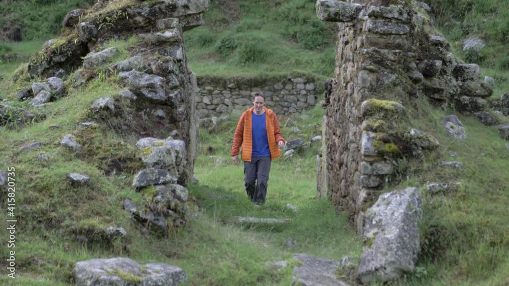 Male model walking in inca archaeological ruins, inca architecture, pre ...