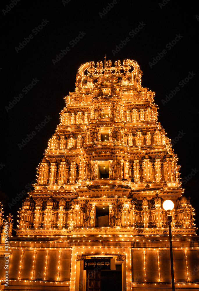 south indian temple entrance gate with blue sky background illuminated ...