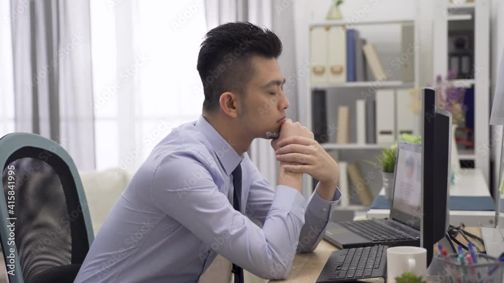 asian manager facing challenge in project planning is staring at ...