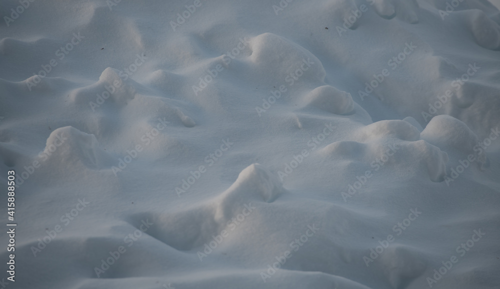 snow landscape made from mounds of snow and snow drifts sunlight ...