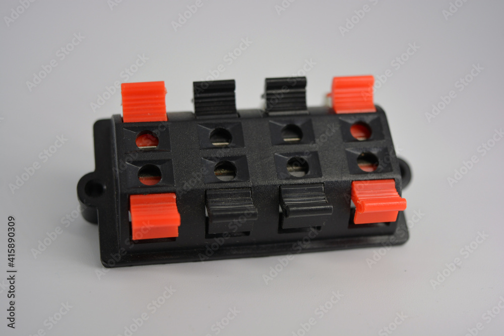 Black electric plastic box for fixing wires with red and black clamps ...