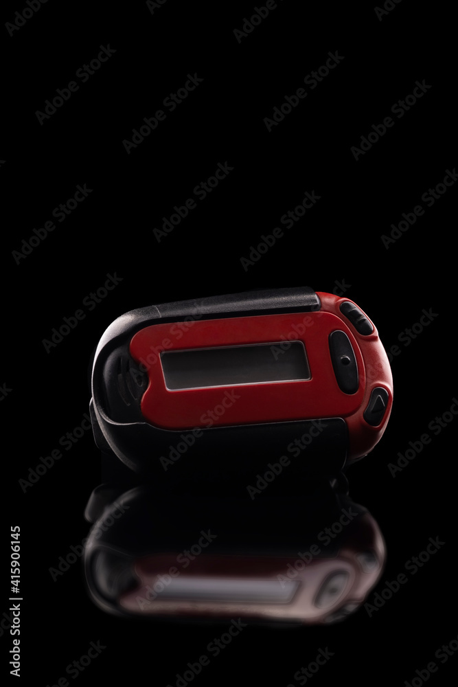 Retro red pager captured isolated on black background and reflective ...