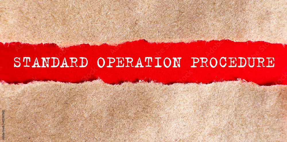 The text Standard Operating Procedure appearing behind torn paper ...