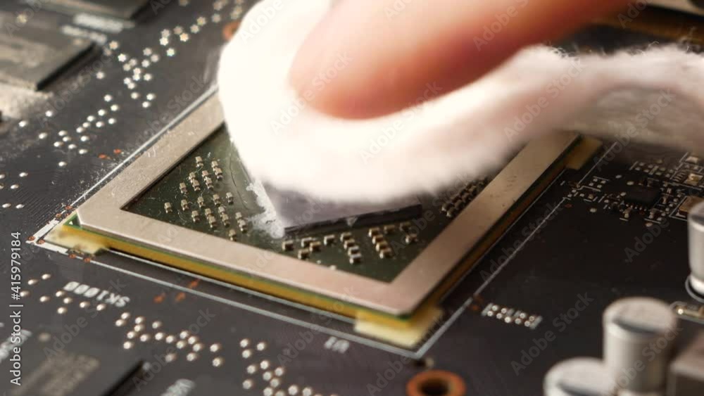 Close-up preparation for installing a heatsink on a personal computer processor, removing old ...
