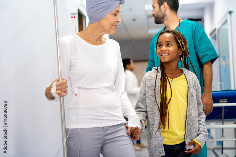 Sick woman with cancer hugging her young grandchild in hospital. Family ...