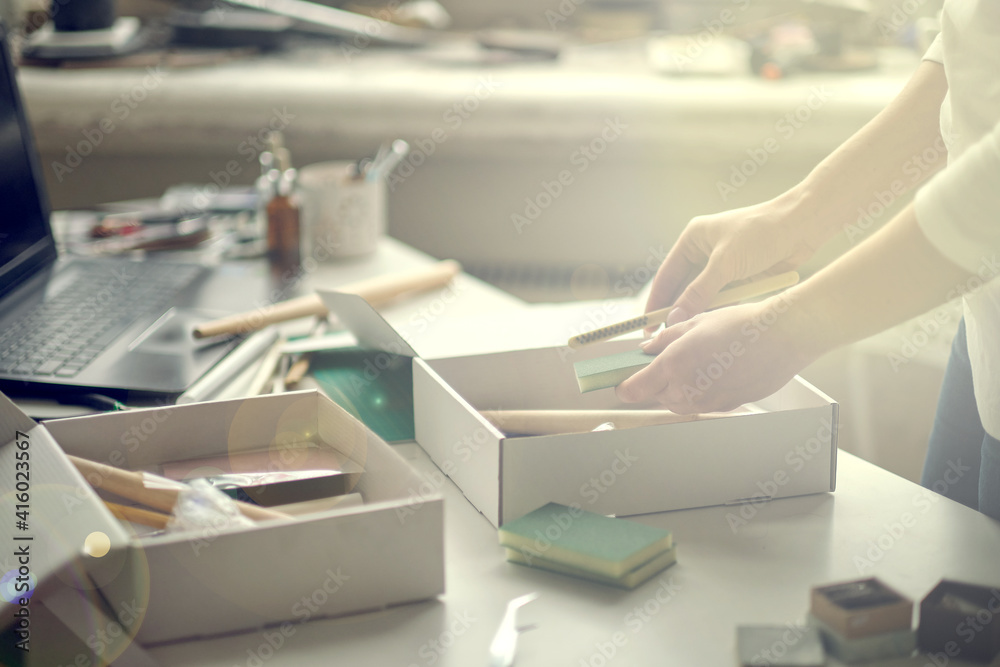 unrecognizable woman takes apart a ready-made set for creativity. a ...