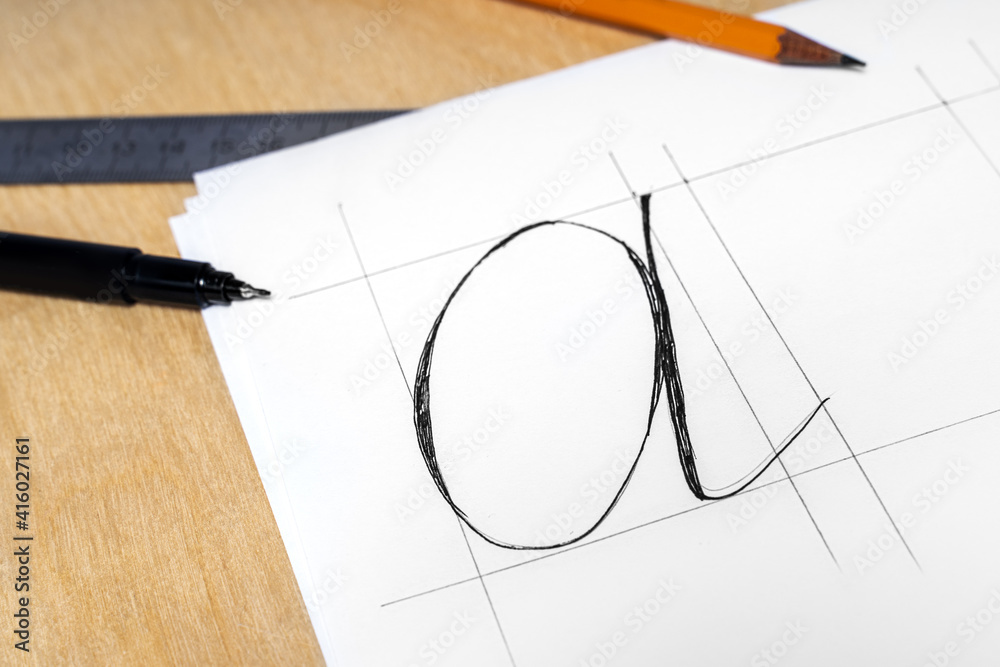 Hand written letter A on white sheet of paper, pencil, ruler and black ...