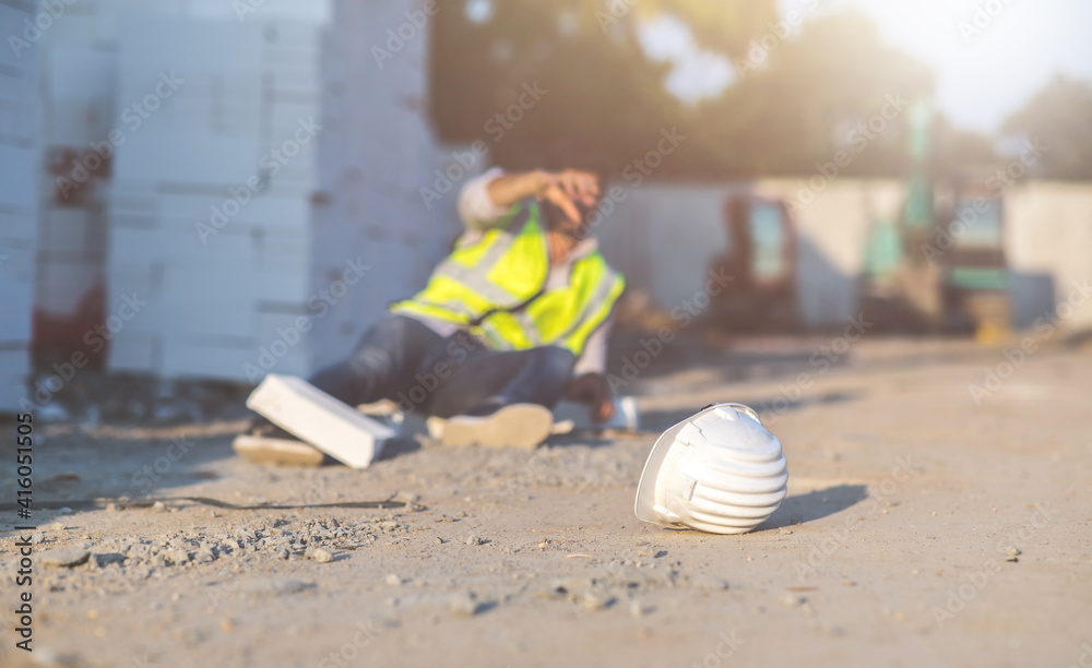 Construction worker has an accident lying on the floor while working in ...