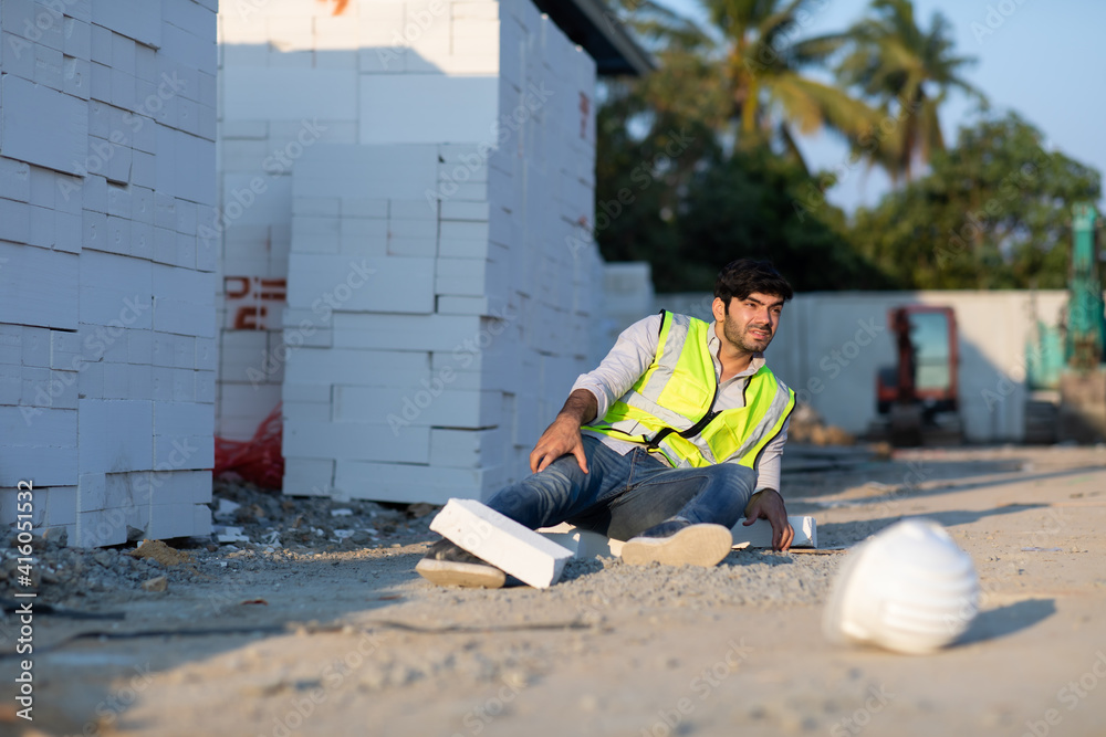 Construction worker has an accident lying on the floor while working in ...