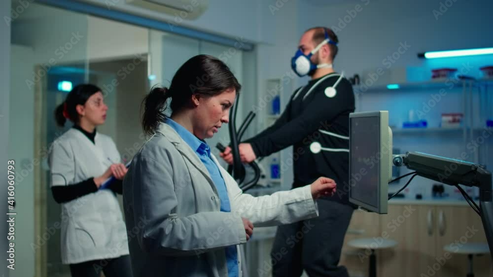 Doctor sport scientist checking EKG scan at monitor and discussing ...