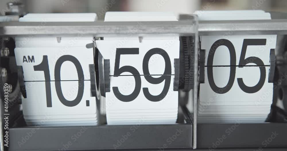 Flip clock or flap clock on white table. An electromechanical, digital ...