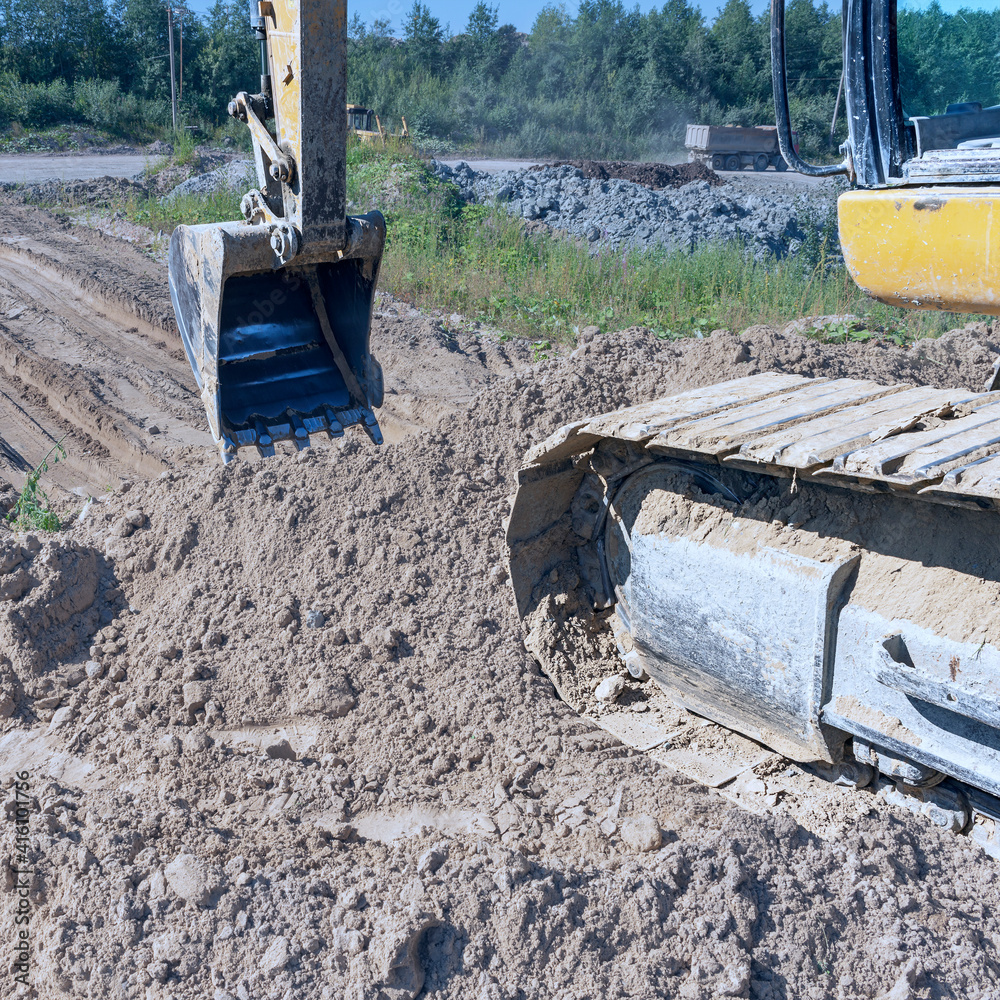 the process of leveling sand with an excavator bucket during the ...