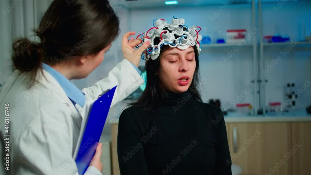 Patient with eeg headset discussing with medical researcher during ...