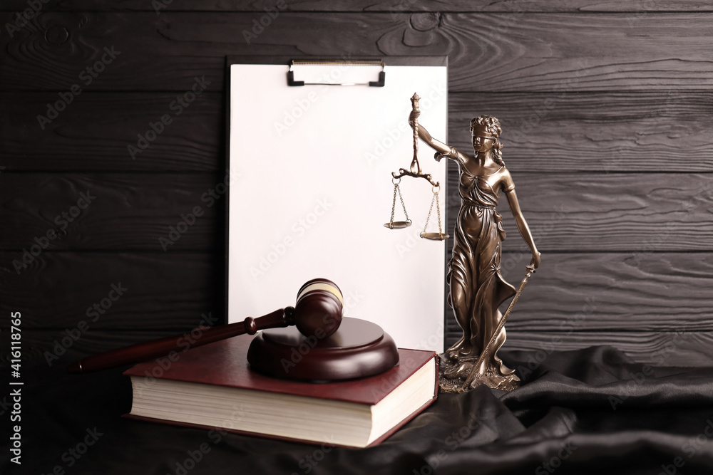 Lady justice or justitia the Roman goddess of Justice. Statue on brown ...