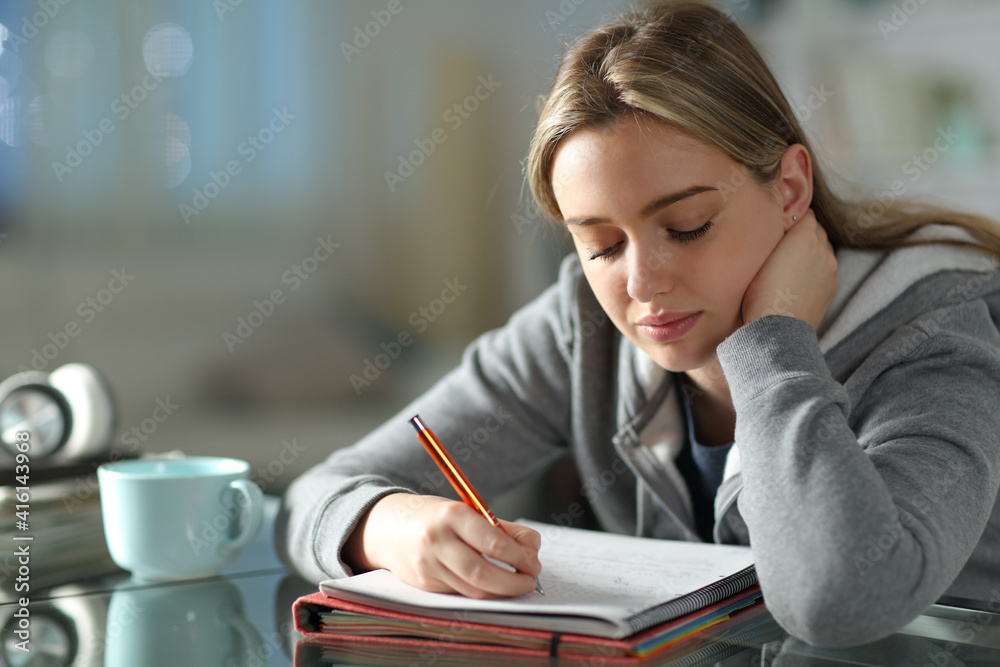 Student learning taking notes in the night at home Stock Photo | Adobe ...