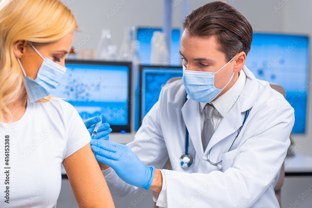 Professional doctor makes a coronavirus vaccine using a syringe and ...